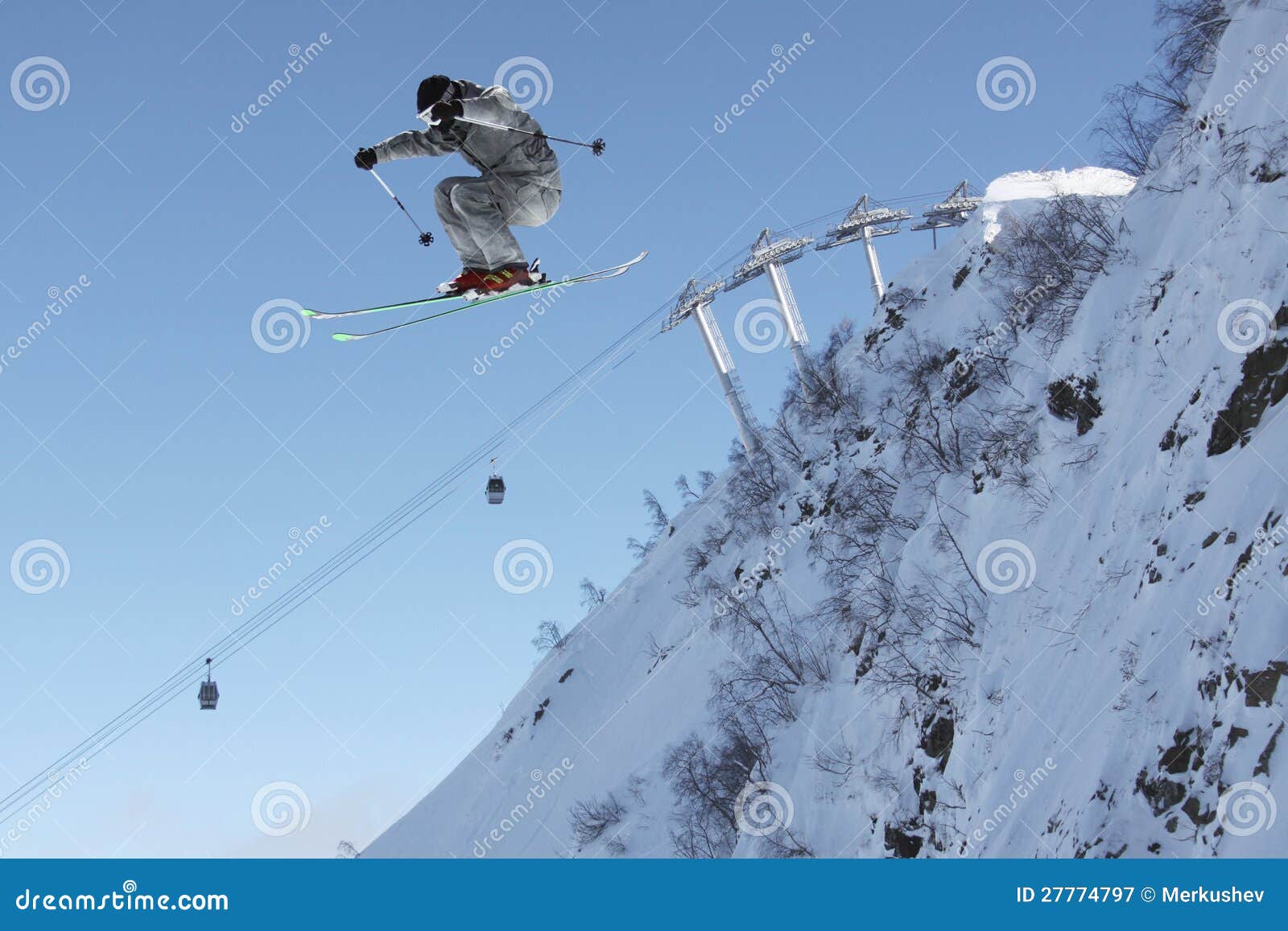 Flying skier on mountains stock image. Image of flying - 27774797