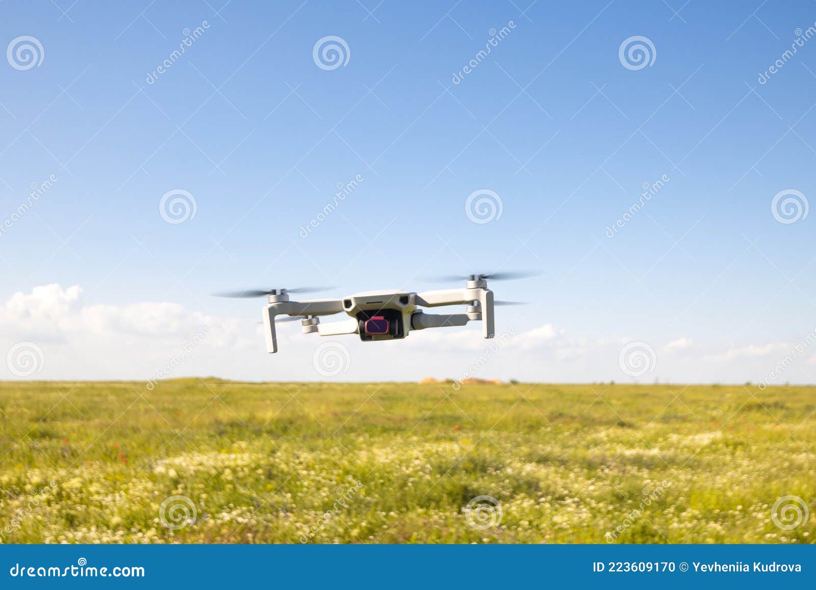 Flying White Drone with Camera in Green Field Stock Photo - Image of ...