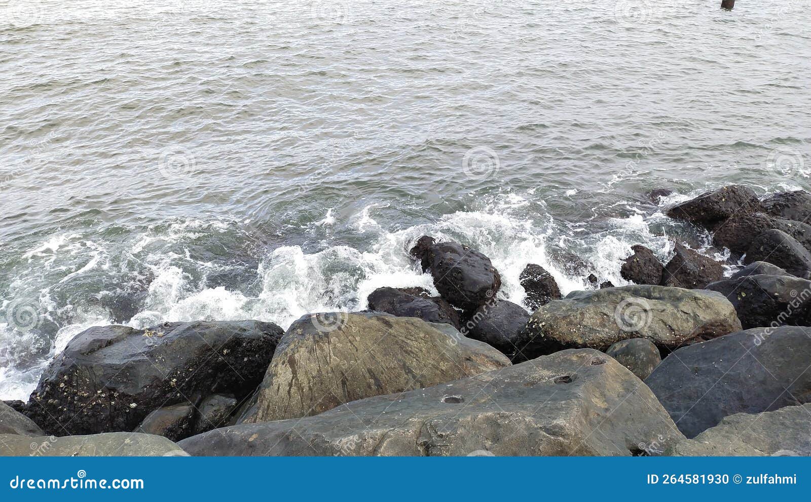 Foam of Sea Water between the Rocks on the Beach Stock Photo - Image of ...