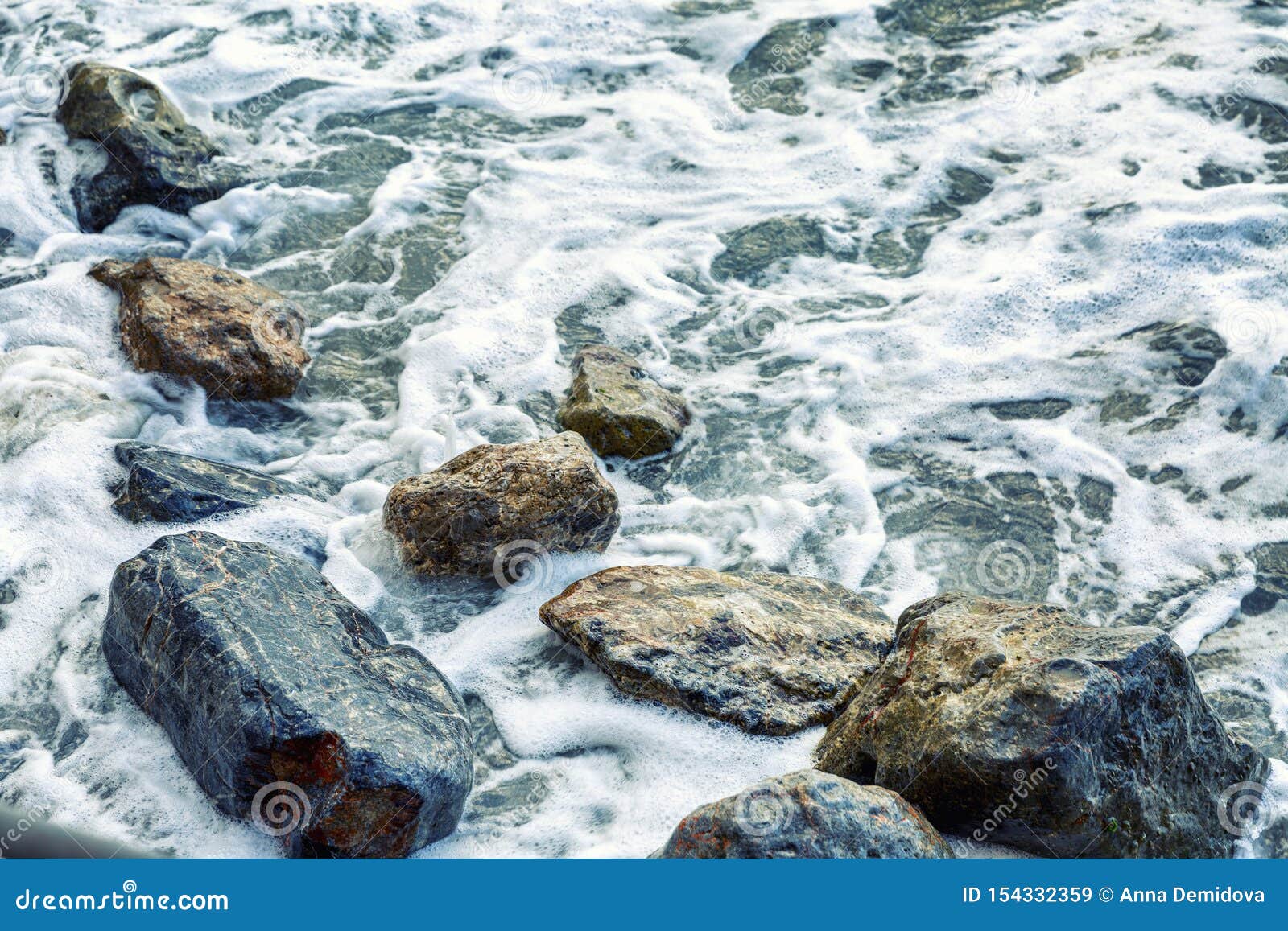 Foamy Sea Waves on Large Rocks on the Shore. Close-up. Background Stock ...