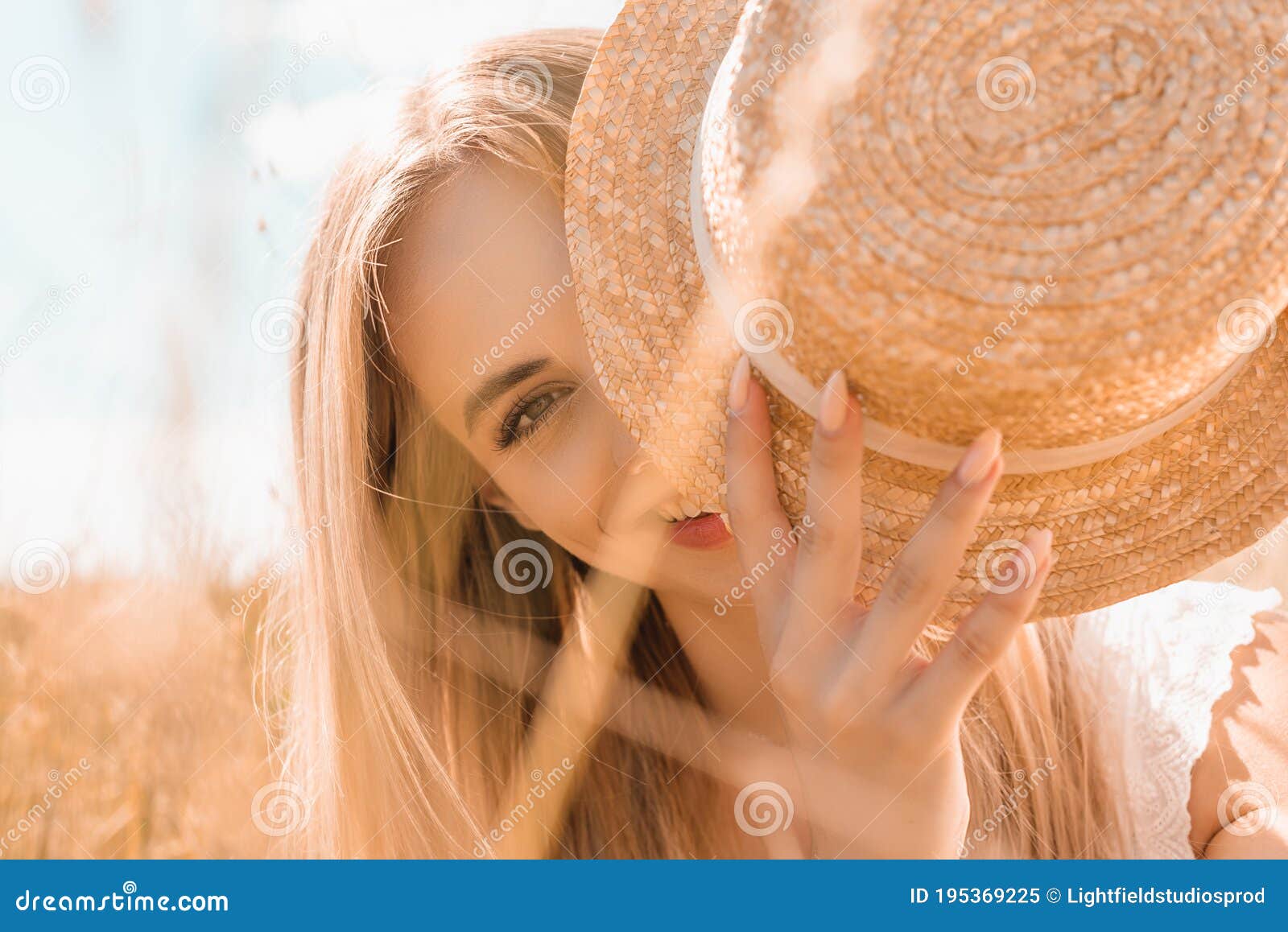 Focus of Blonde Woman Obscuring Face Stock Image - Image of blue ...