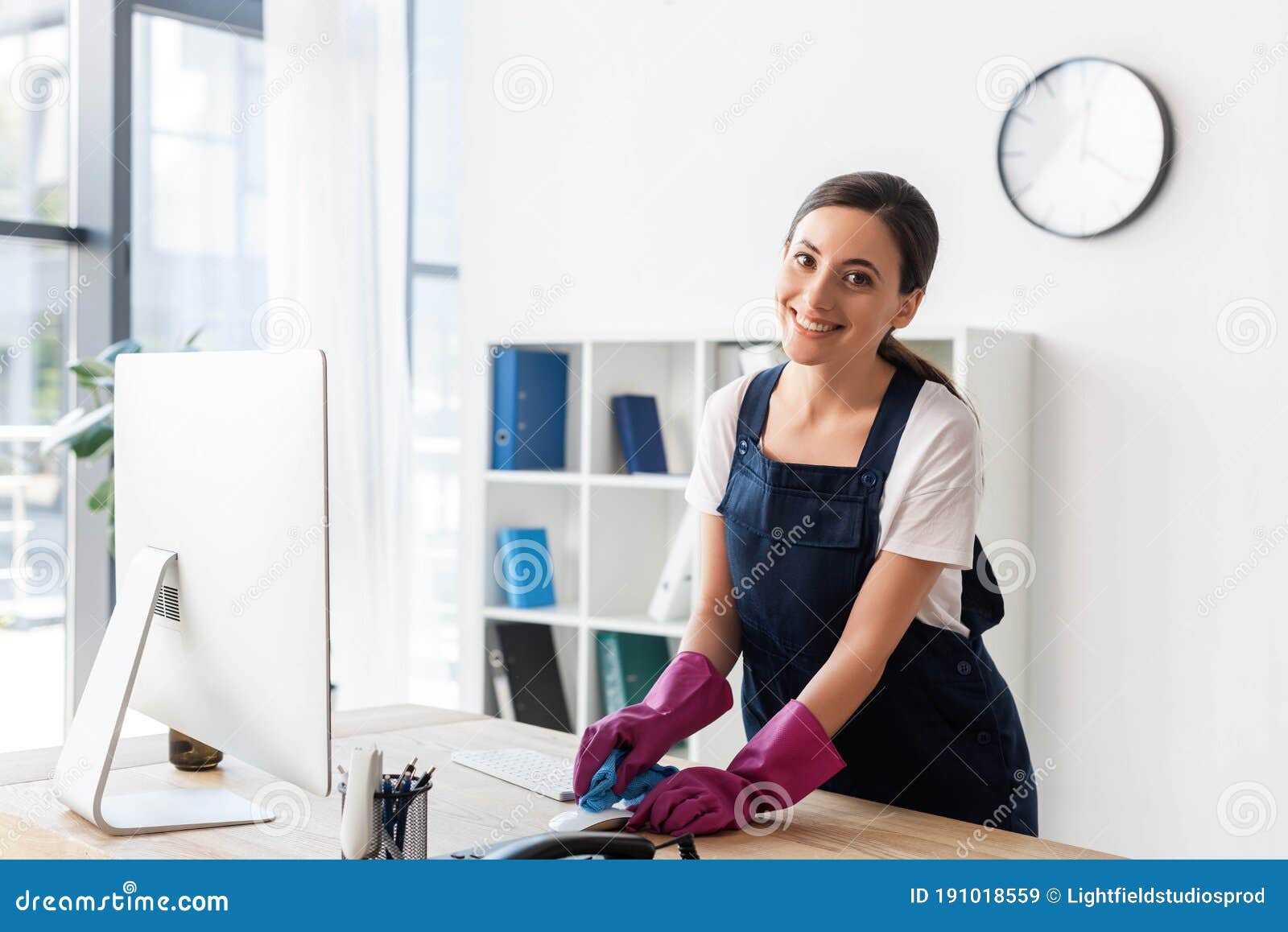 Focus of Cleaner Smiling at Camera while Cleaning Computer Mouse on ...