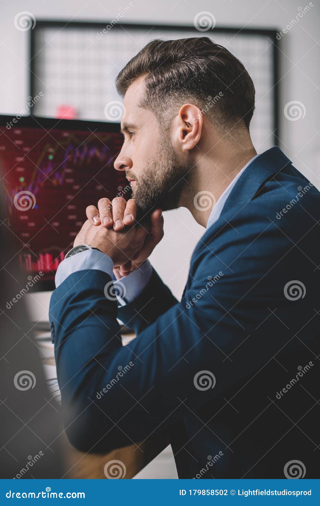 Focus of Computer Systems Analyst Looking at Charts on Computer Monitor ...