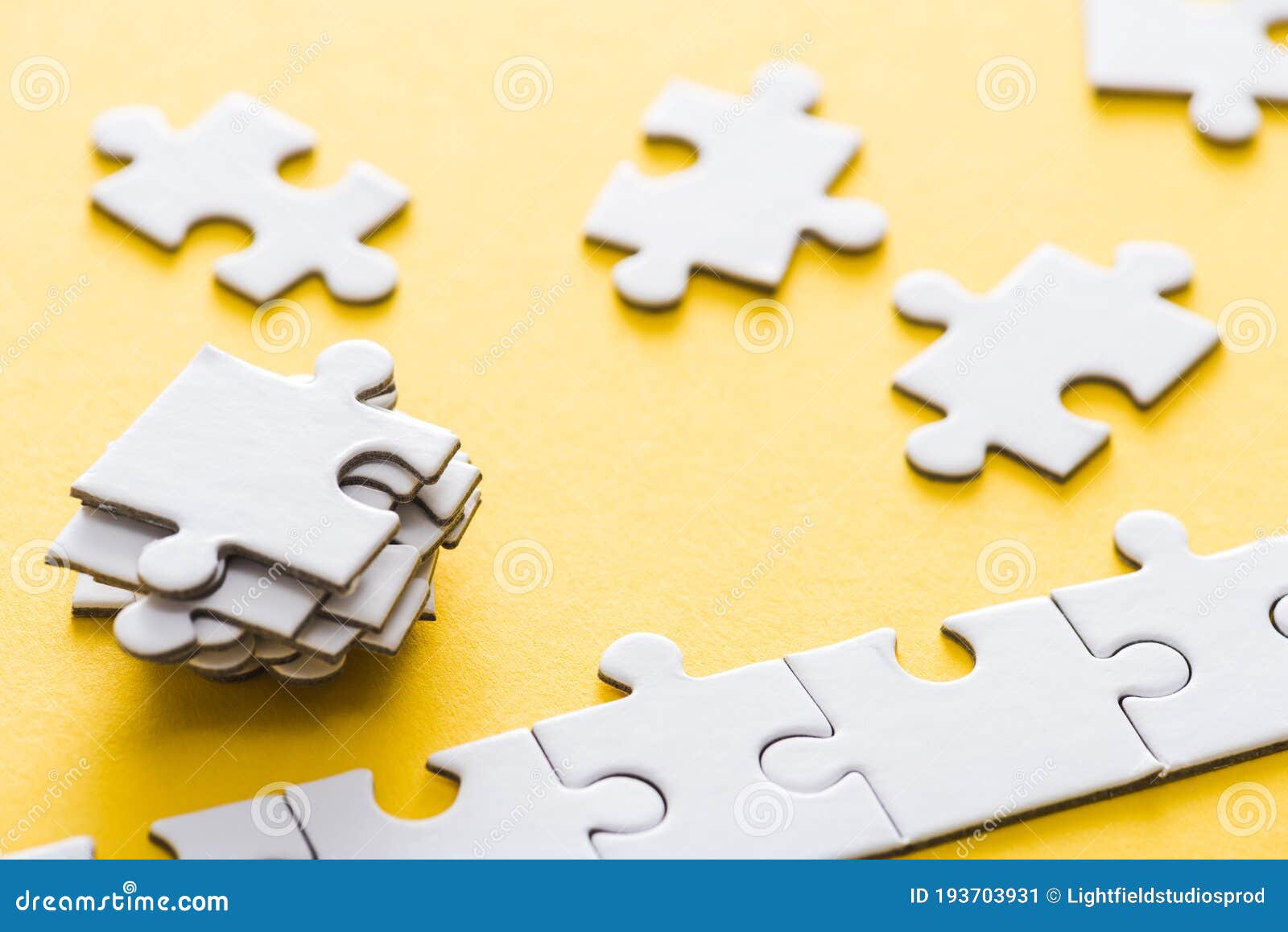 Focus of Connected Jigsaw Near Stack of Puzzle Pieces on Yellow Stock ...