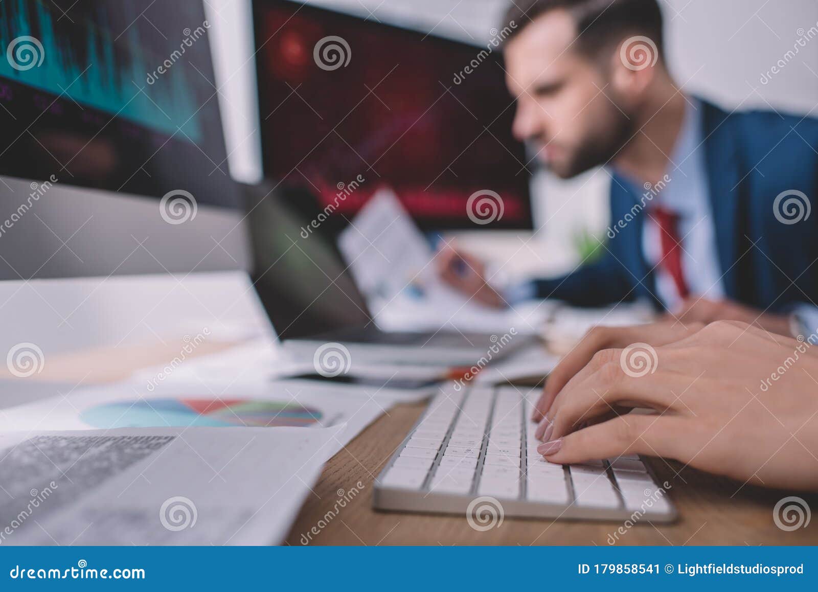 Focus of Data Analyst Typing on Computer Keyboard Near Colleague at ...