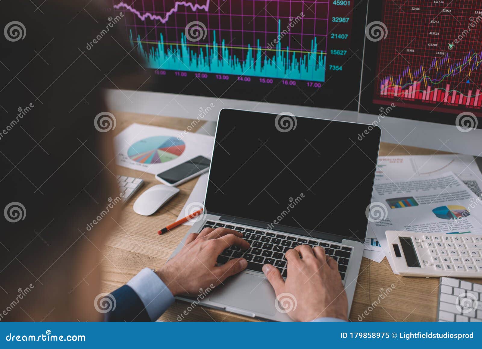 Focus of Data Analyst Using Laptop Near Charts on Papers and Computer ...