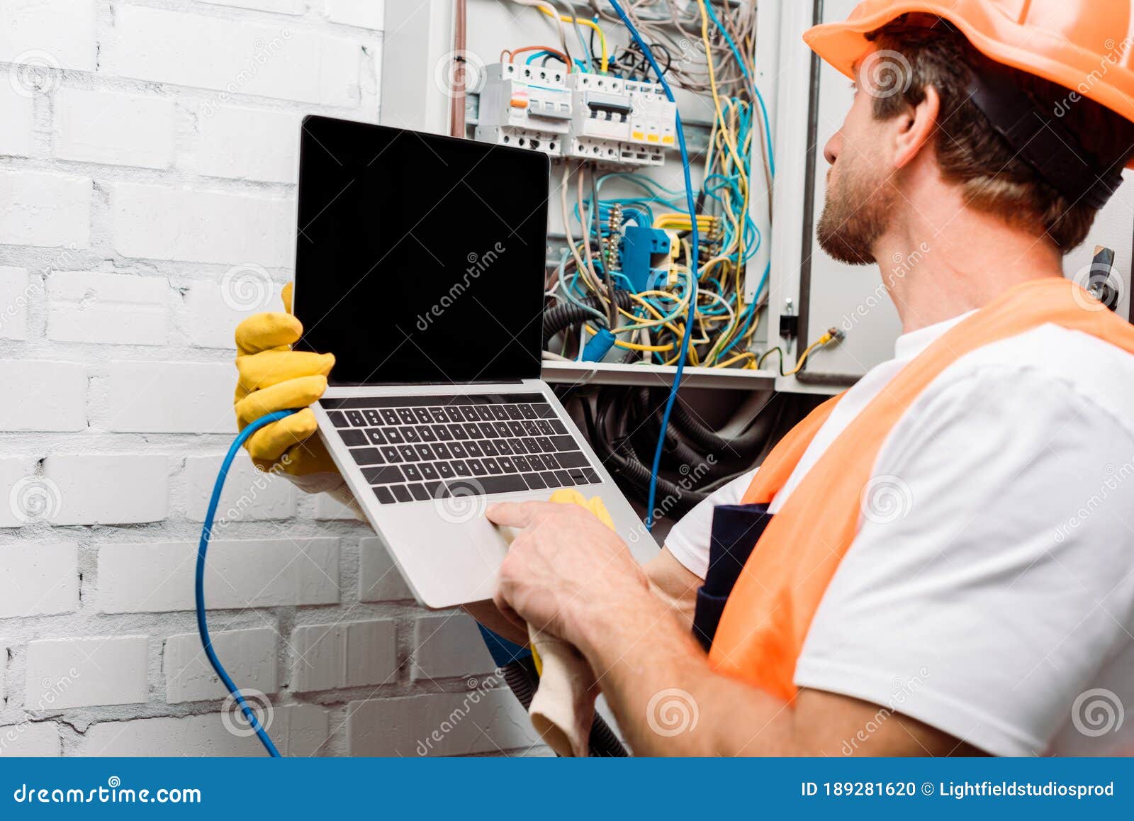 Focus of Electrician Using Laptop Near Stock Photo - Image of ...
