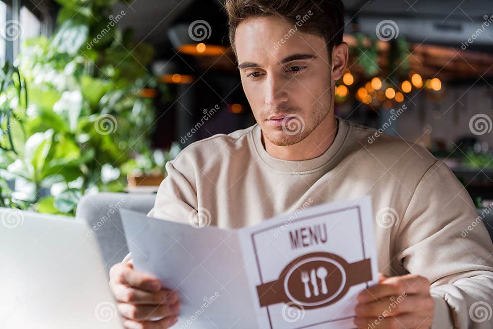 Focus of Handsome Man Holding Menu in Restaurant Stock Photo - Image of ...