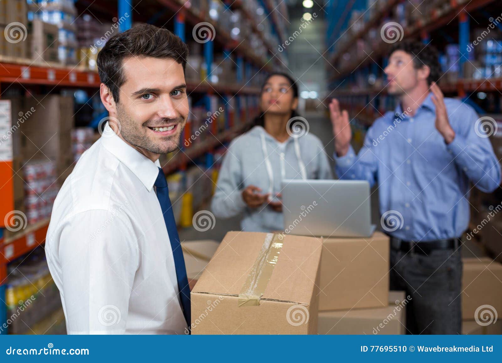 Focus of Manager Holding Cardboard Box and Smiling in Front of Workers ...