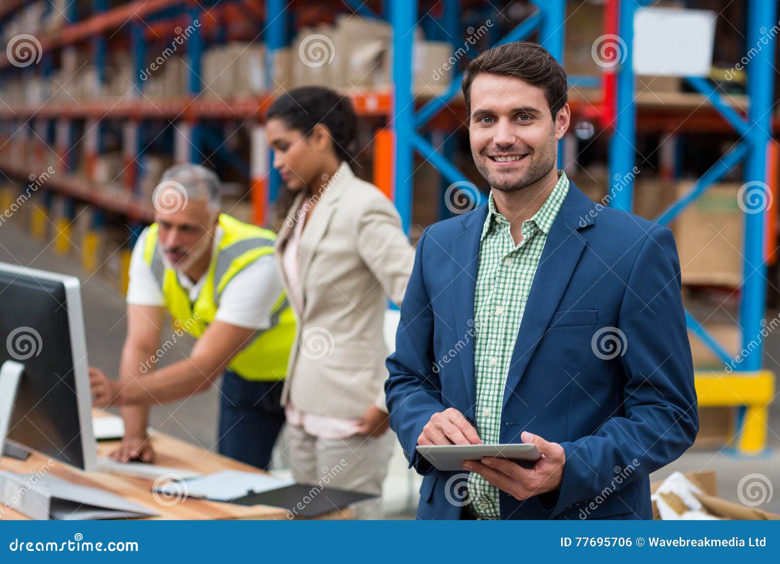 Focus on Manager is Smiling and Holding a Tablet in Front of His ...