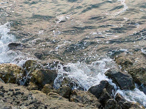 Focus on the Rocks that are Being Swept by the Ocean Waves Stock Photo ...
