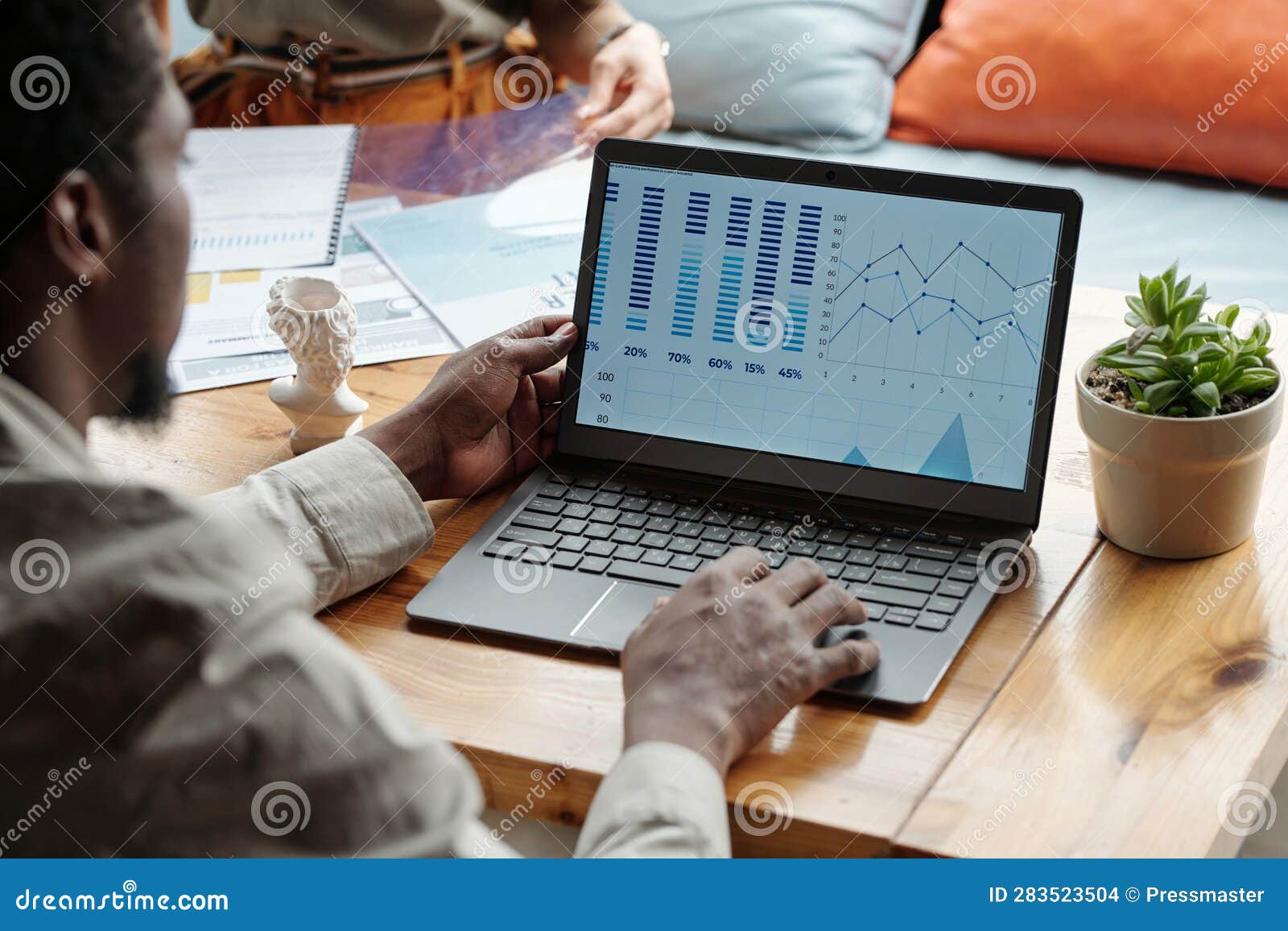 Focus on Screen of Laptop with Graphic Financial Data on Workplace ...