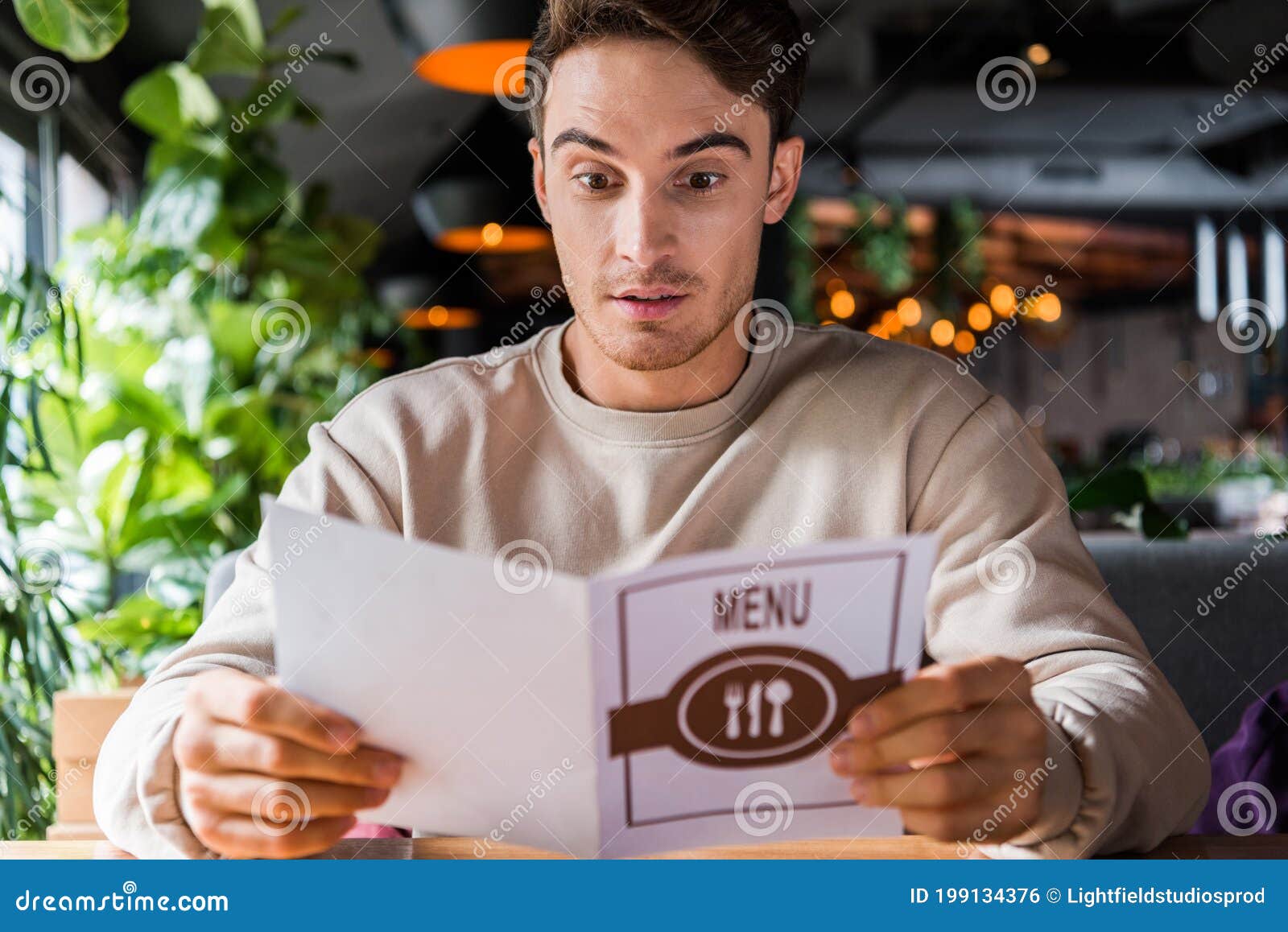 Focus of Surprised Man Holding Menu in Restaurant Stock Photo - Image ...