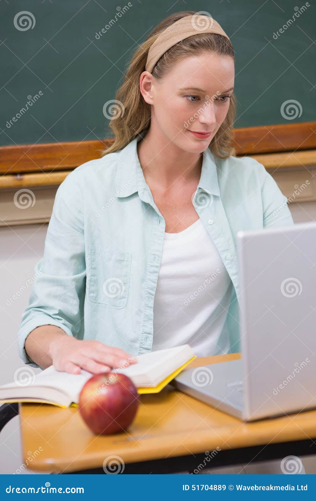 Focus teacher at her desk stock image. Image of class - 51704889