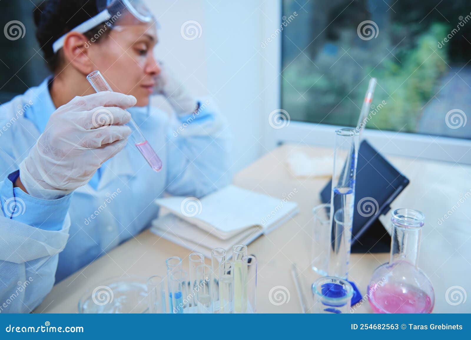 Focus on Test Tube with a Solution, in the Hands of a Blurred Female ...