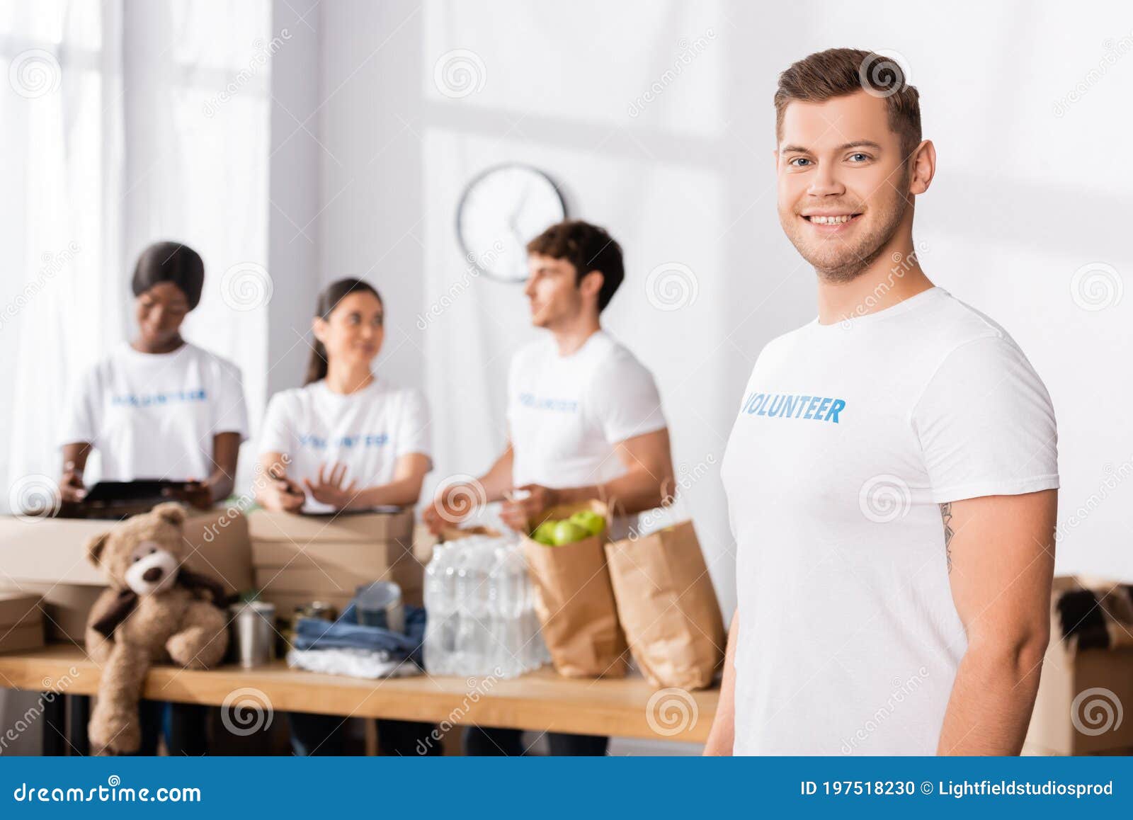 Focus of Volunteer Looking at Camera Stock Photo - Image of multiethnic ...