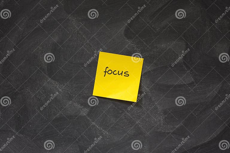 Focus on Yellow Sticky Note Against Blackboard Stock Photo - Image of ...