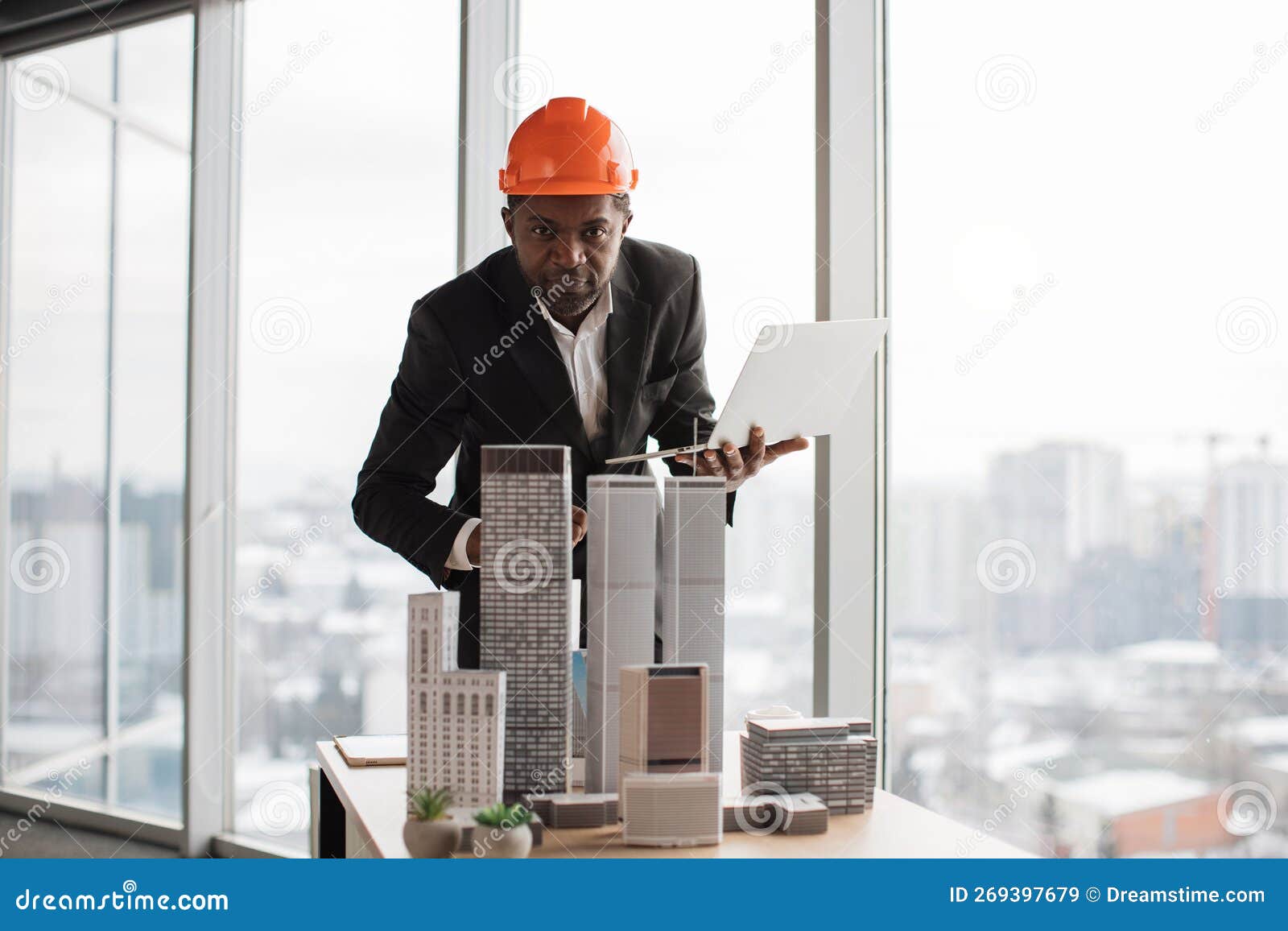 Focused African Inspector Using Laptop Inspecting Skyscraper Model in ...