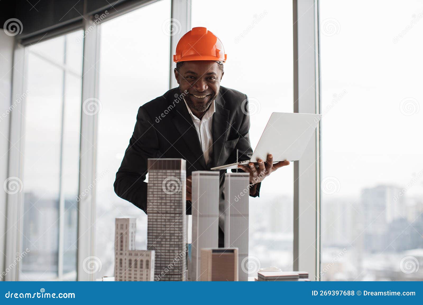 Focused African Inspector Using Laptop Inspecting Skyscraper Model in ...