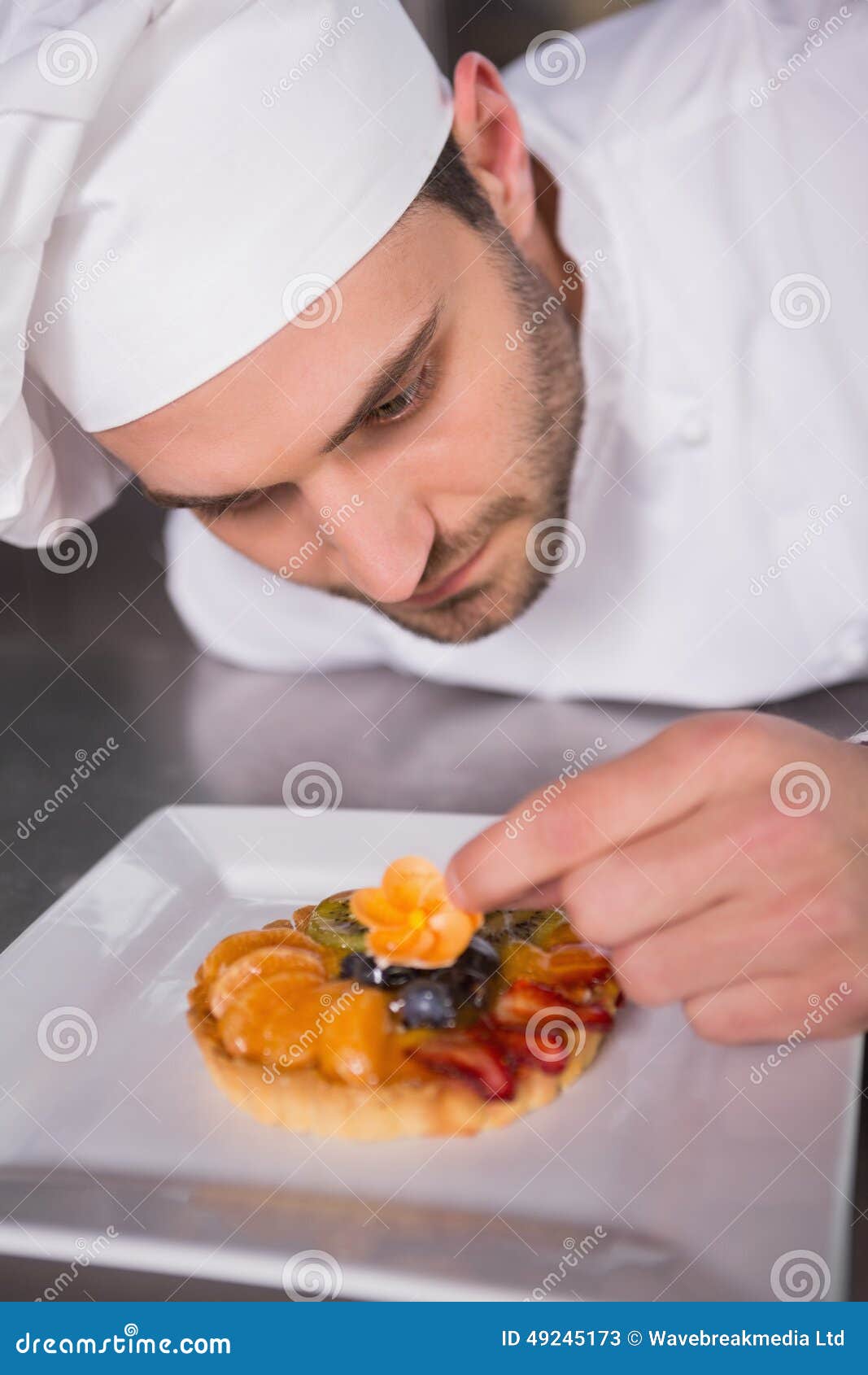 Focused Baker Putting Flower on the Pastry with Fruit Stock Image ...