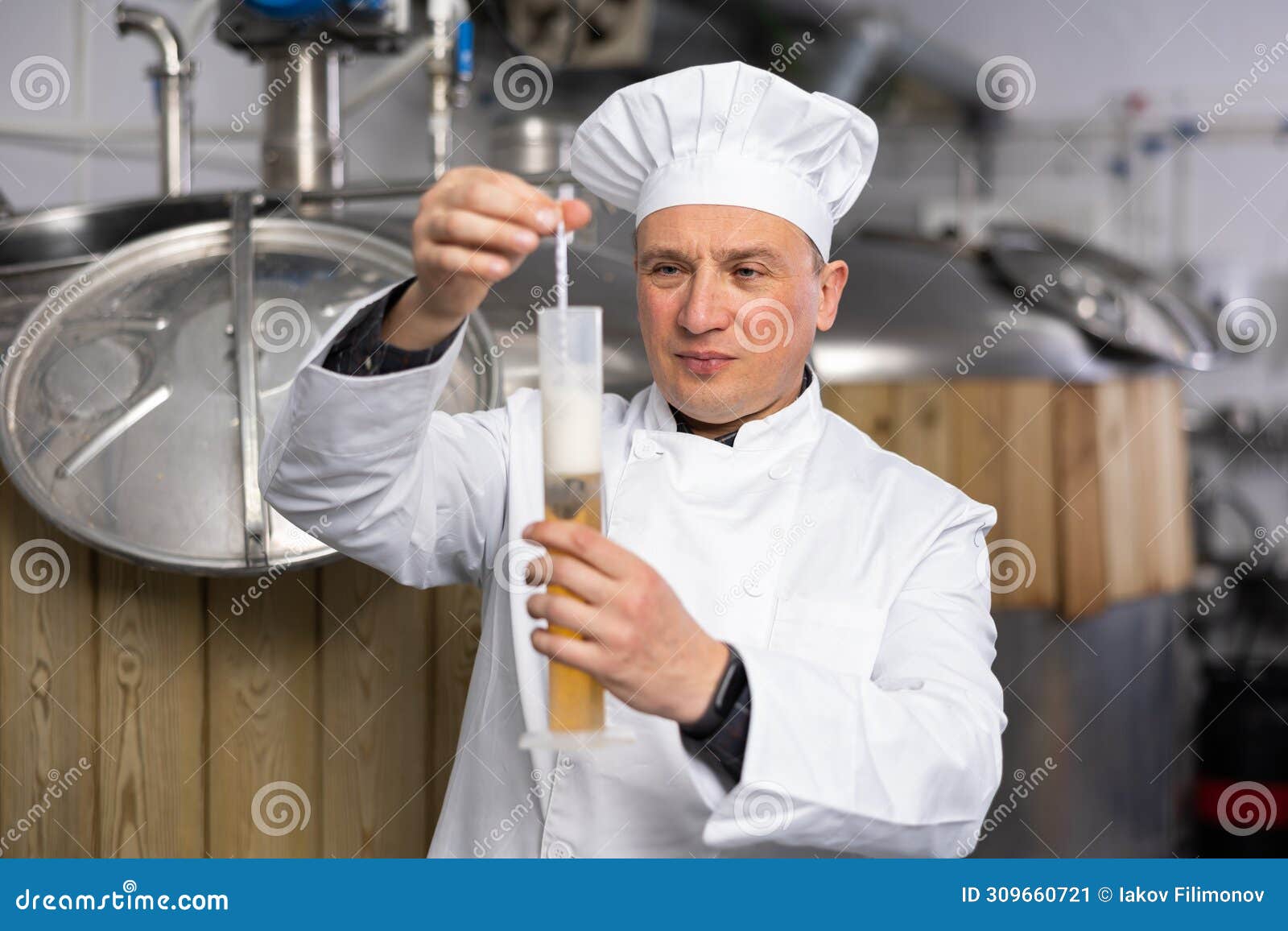 Focused Brewer Measuring Beer Gravity with Hydrometer in Brewery Stock ...