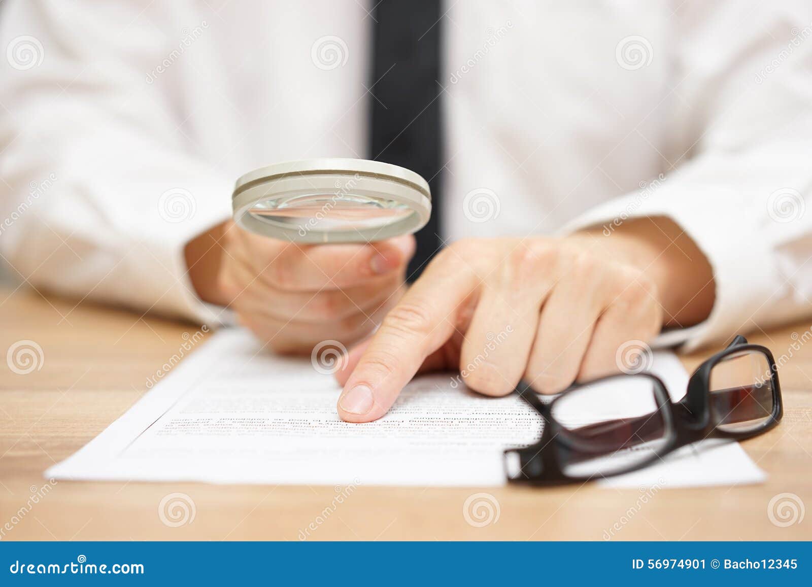 Focused Businessman is Reading through Magnifying Glass Stock Image ...