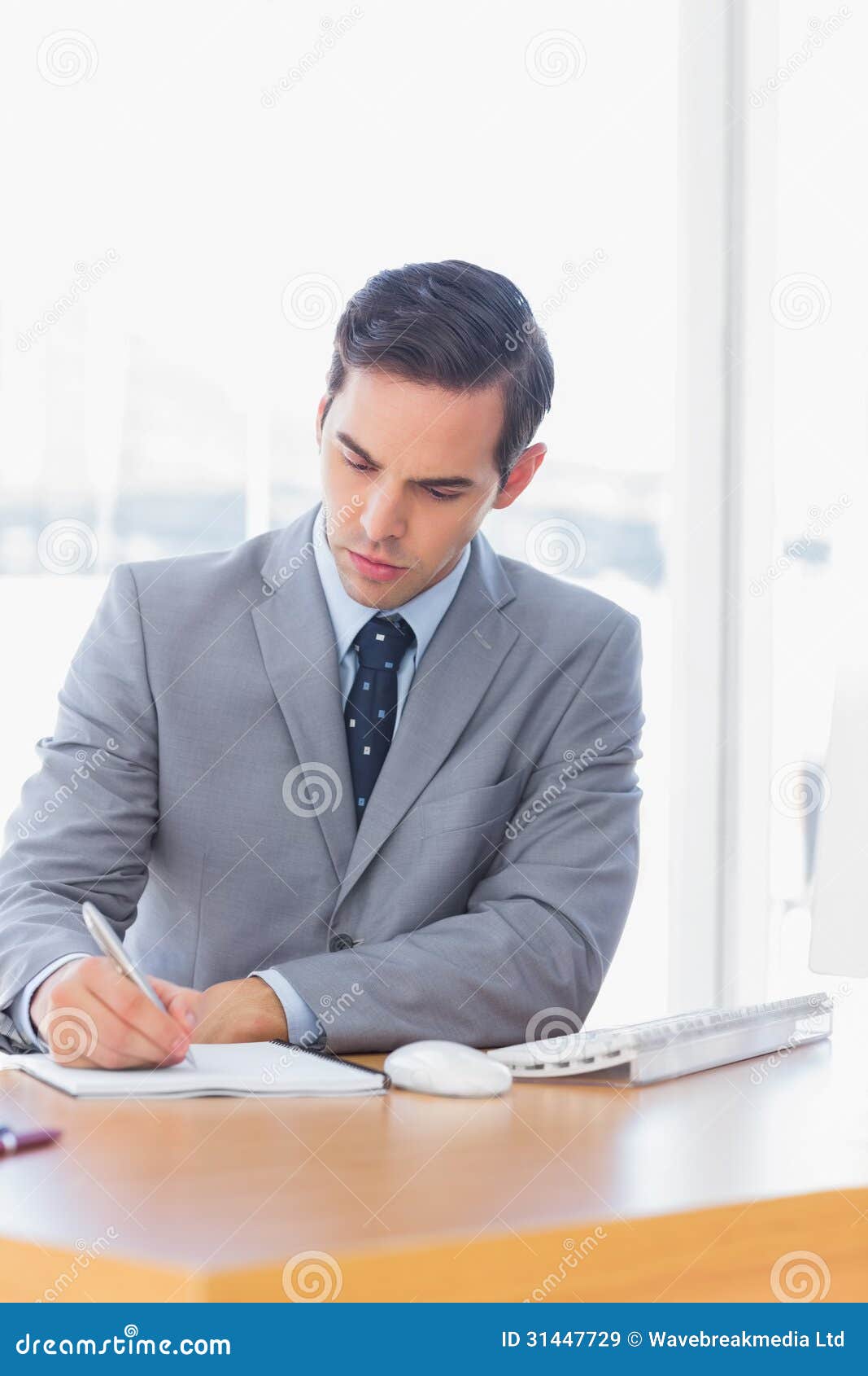 Focused Businessman Writing at His Desk Stock Image - Image of notepad ...
