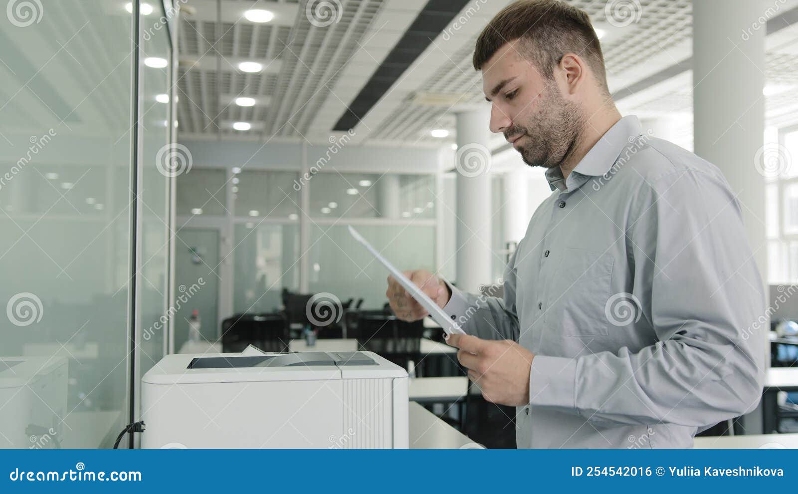 Focused Caucasian Male Professional Worker Manager Prints Documents on ...