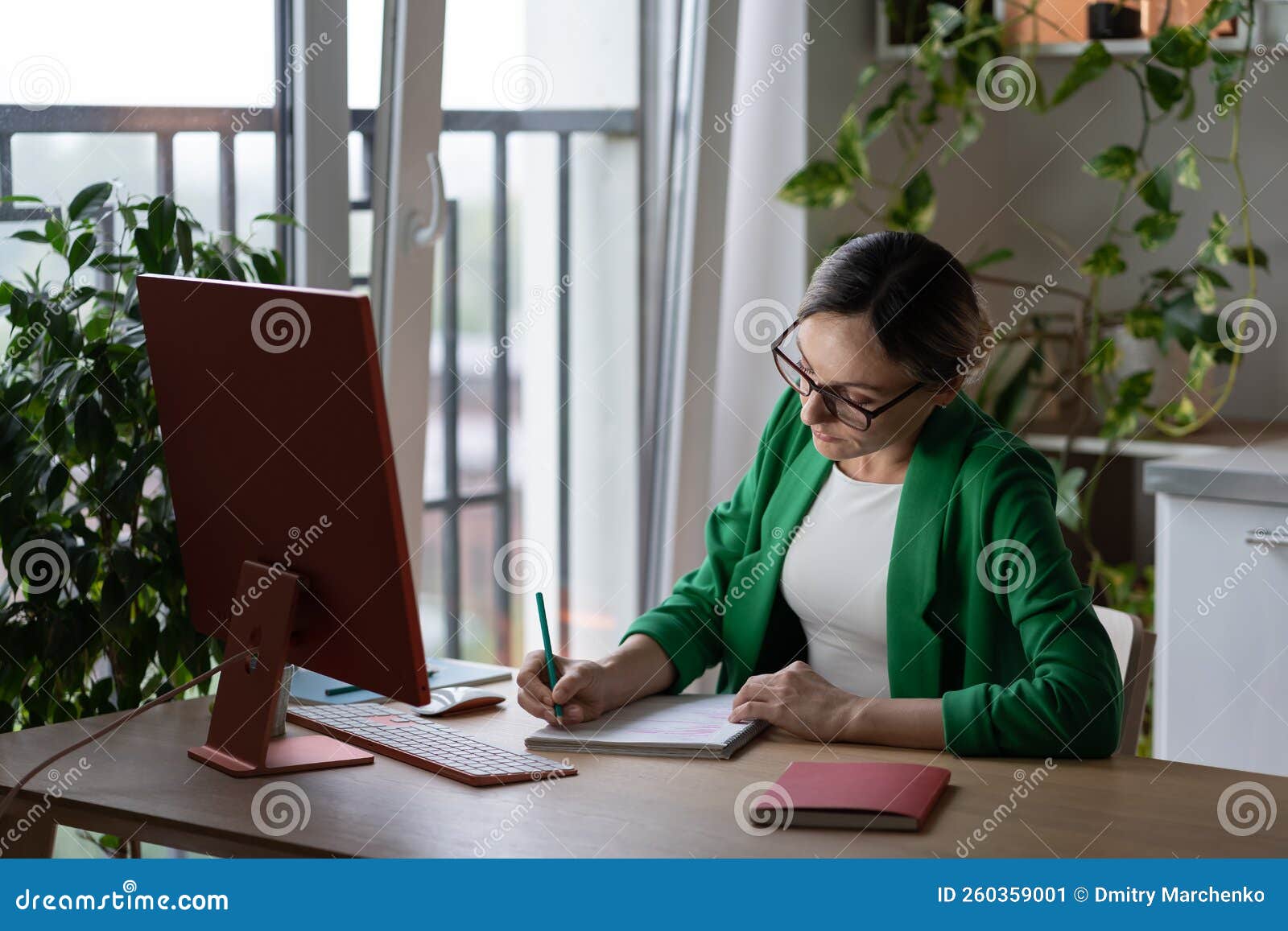 Focused Caucasian Woman Tutor or Teacher Making Notes in Notebook Sits ...