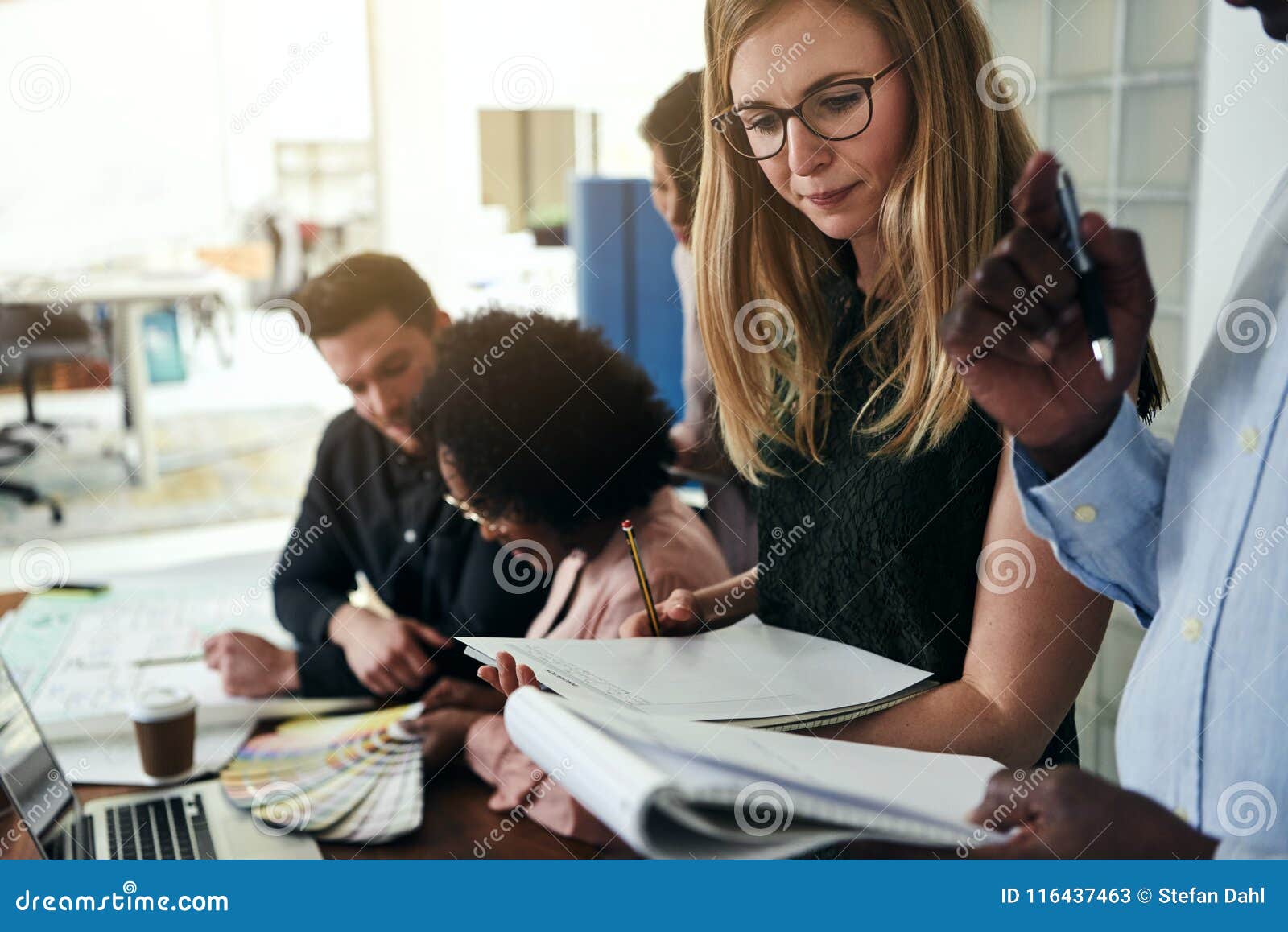 Focused Colleagues Comparing Notes Together in a Modern Office Stock ...