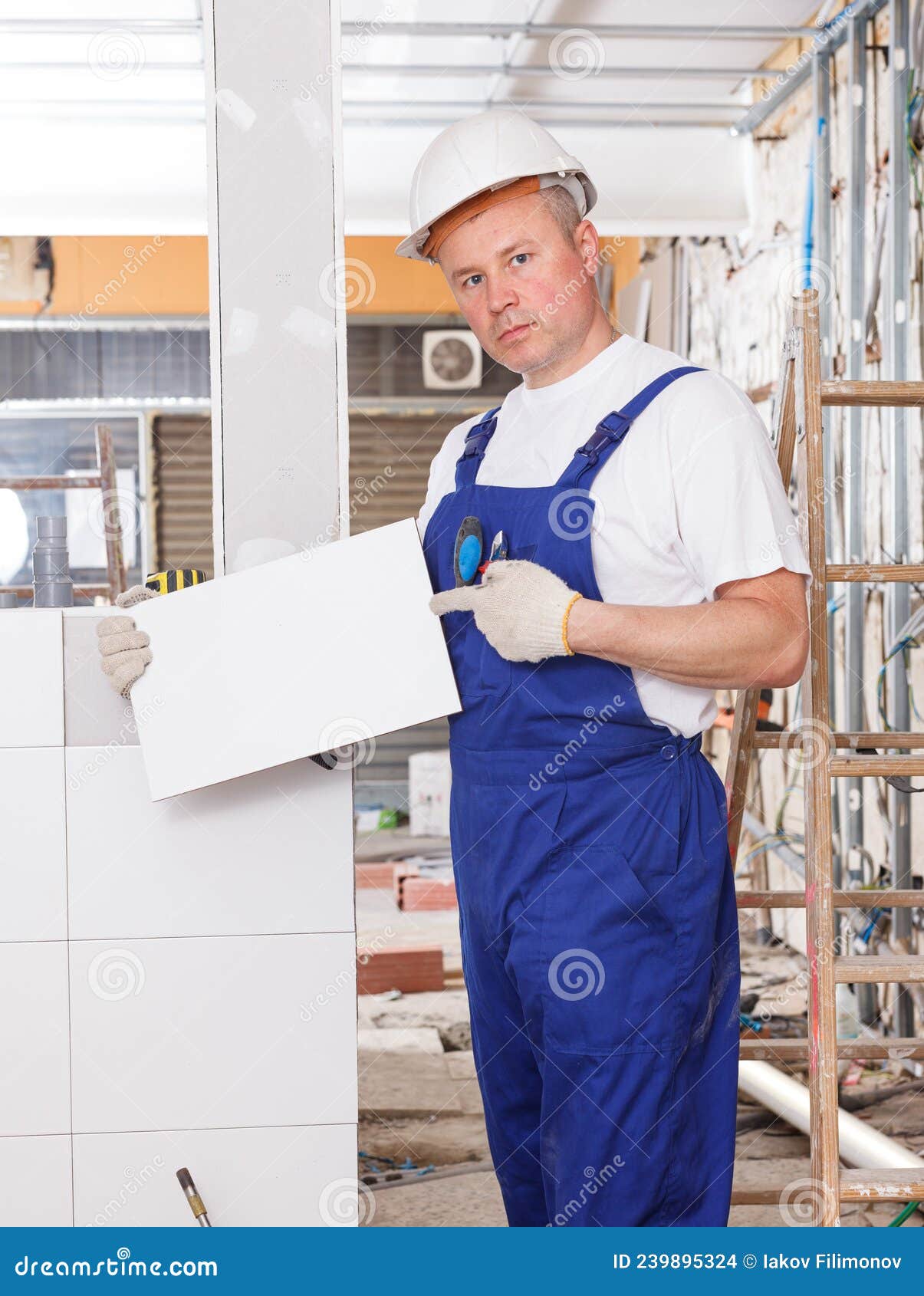 Worker Engaged in Wall Tiling Work Stock Photo - Image of equipment ...