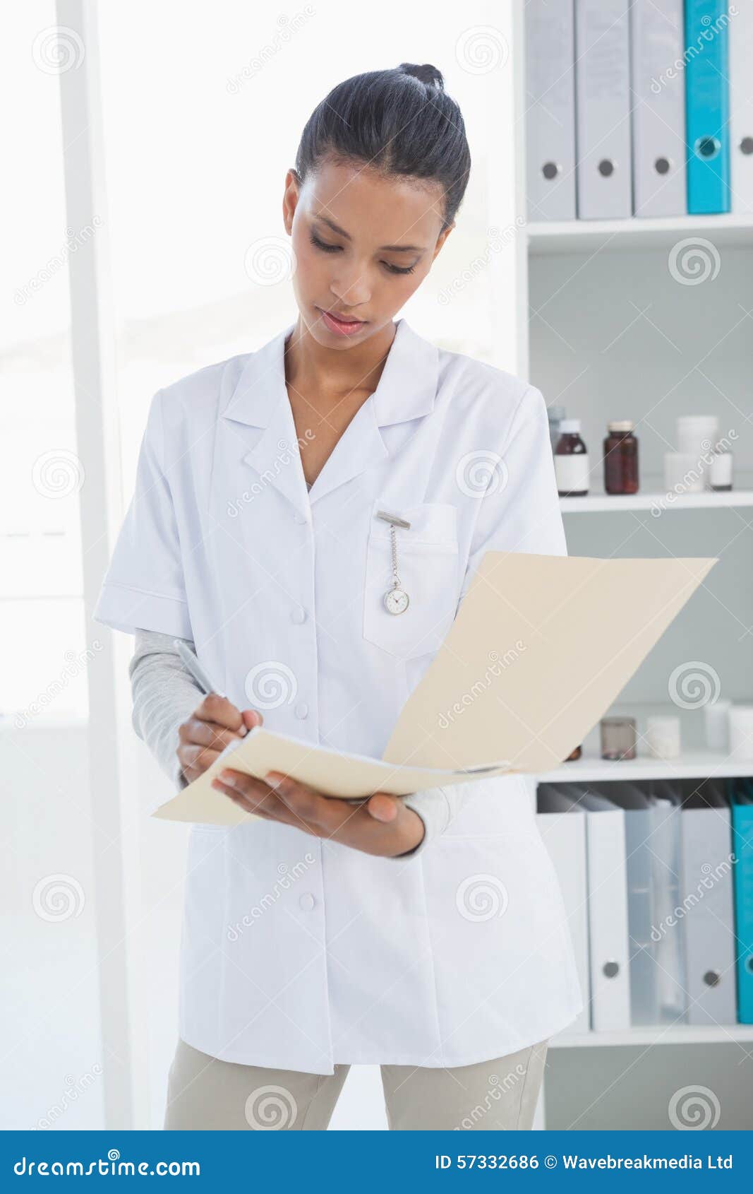 Focused Doctor Writing Down Notes Stock Photo - Image of brunette ...