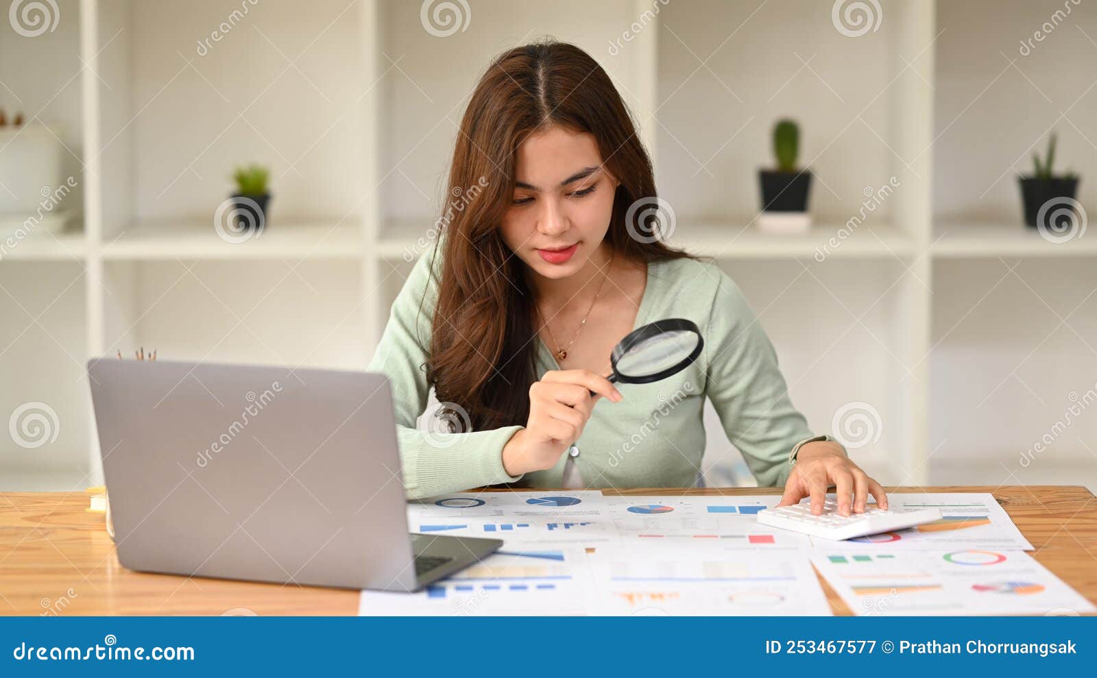 Focused Female Auditor Examining the Numerical Data on Financial ...