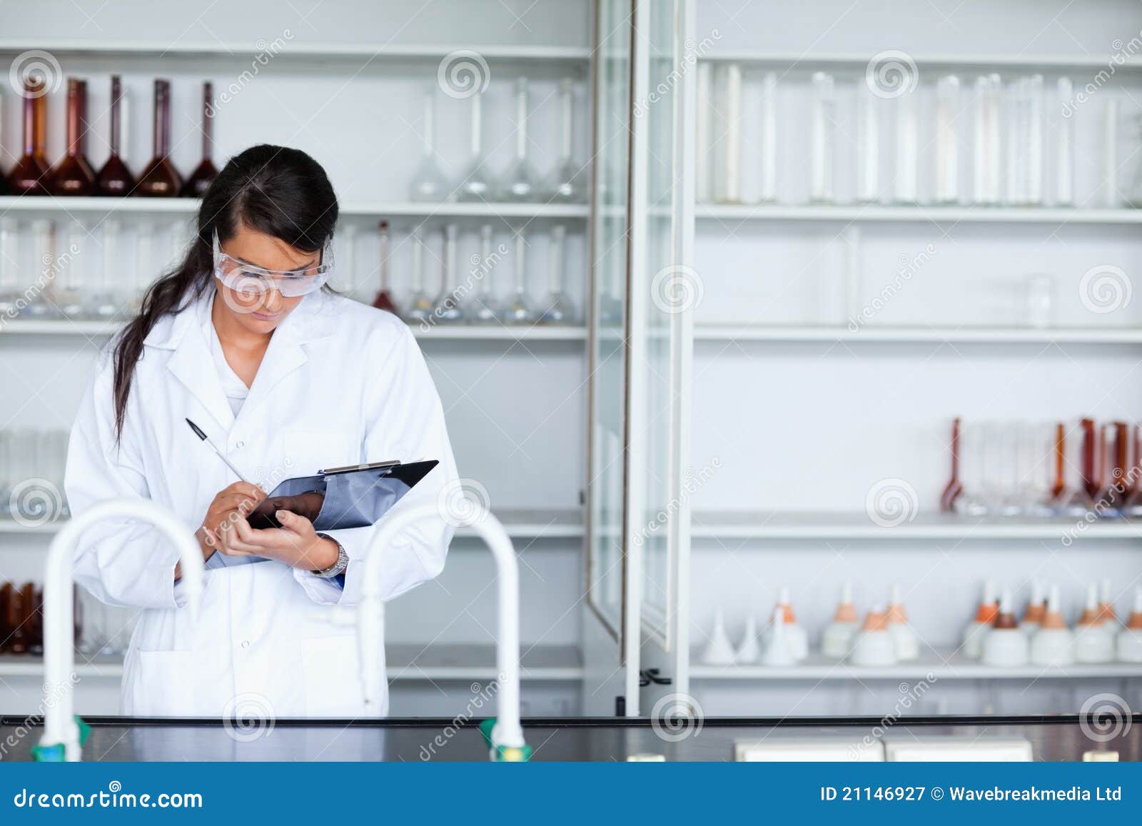 Focused Female Scientist Writing on a Clipboard Stock Image - Image of ...