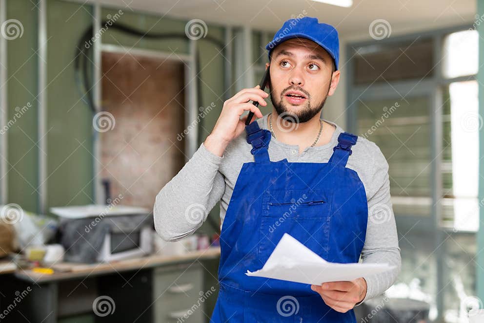 Foreman Talking on Phone at Renovating Object Stock Photo - Image of ...
