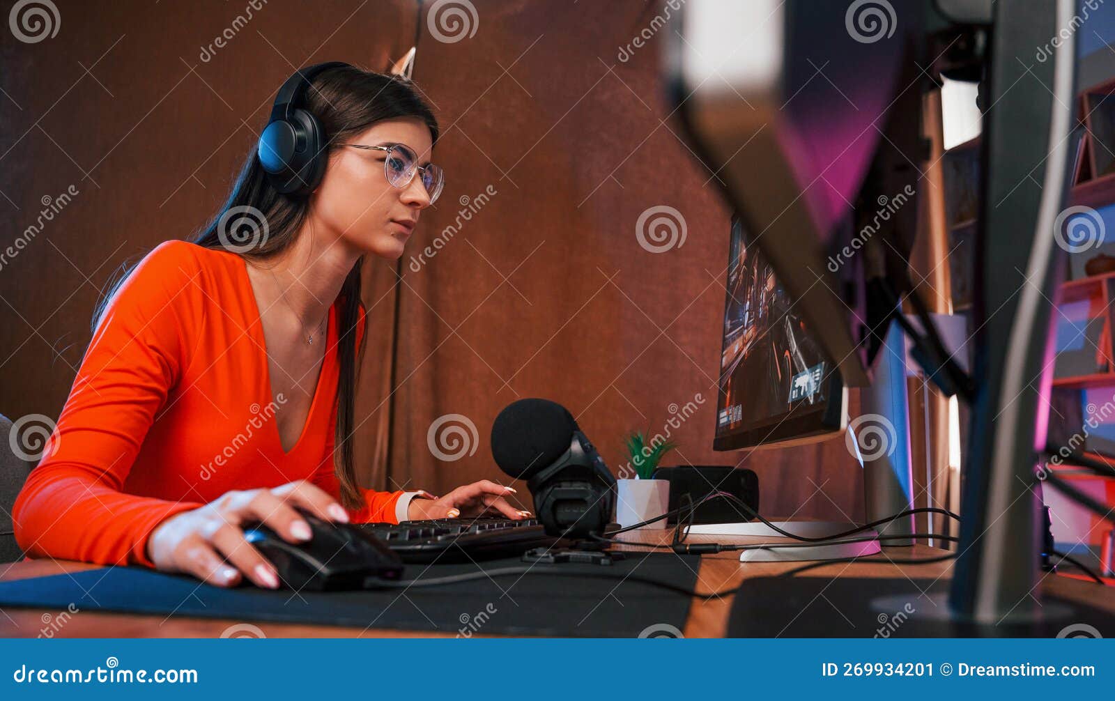 Focused on the Game Process. Young Beautiful Streamer is Indoors with ...