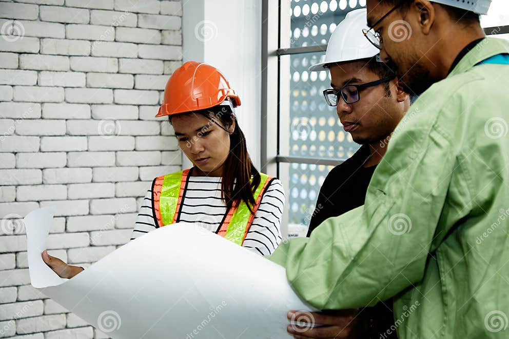 A Focused Group of Engineer and Contractor Going Over Plans ...