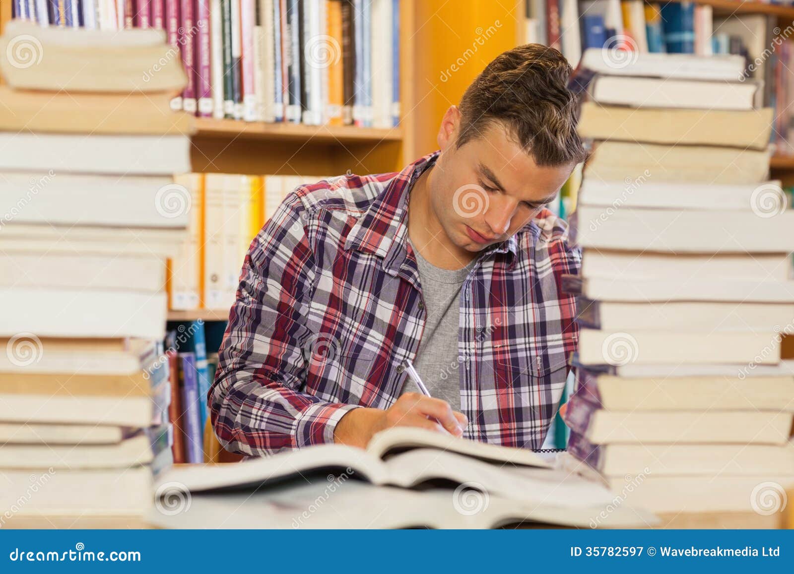 Focused Handsome Student Studying between Piles of Books Stock Image ...