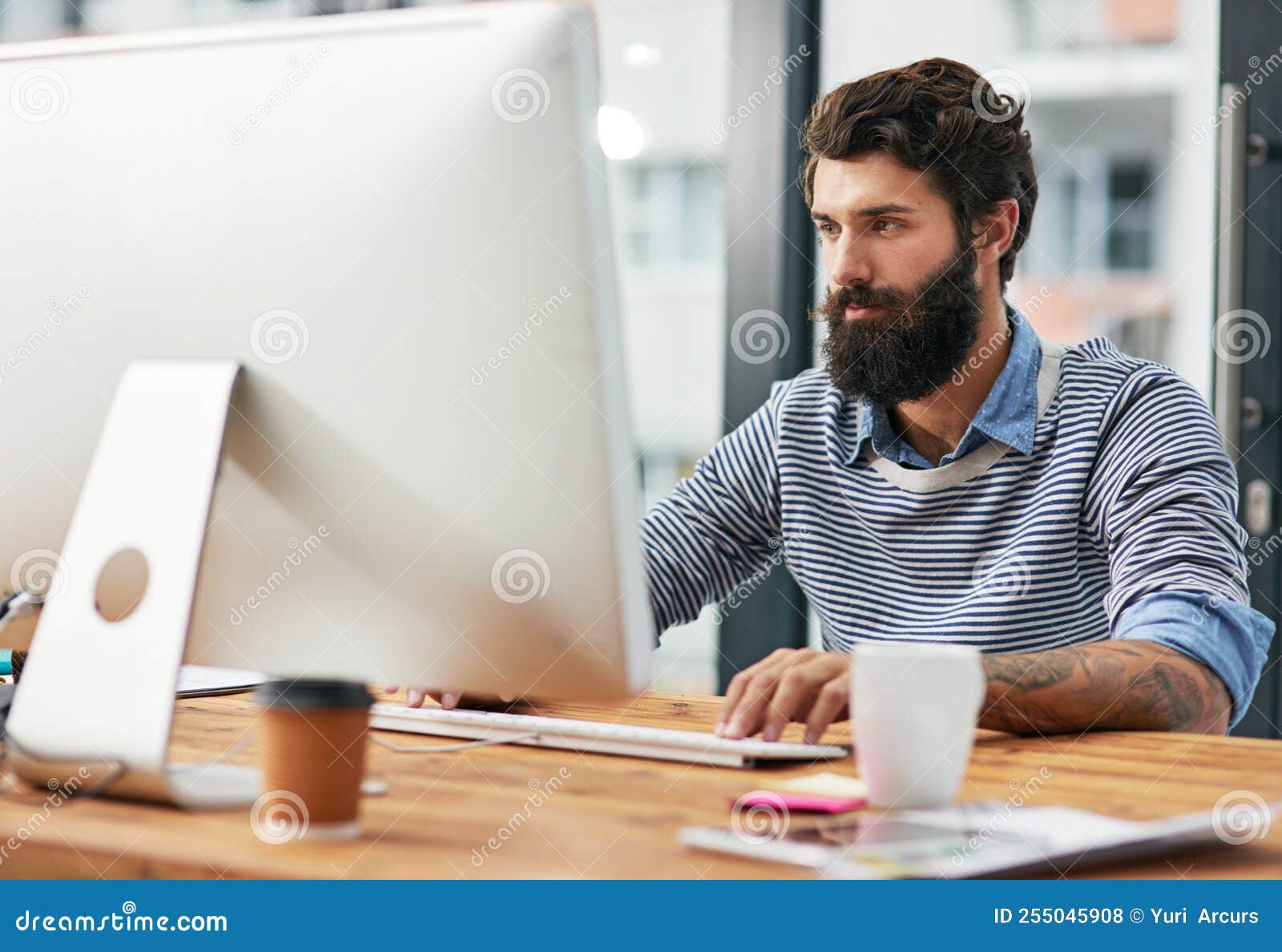 Focused on His Big Ambitions. a Young Creative Working on a Computer in ...