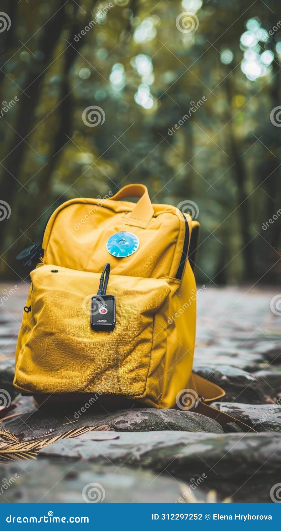 Focused Image of a Yellow Backpack with an Emergency Contact Device and ...