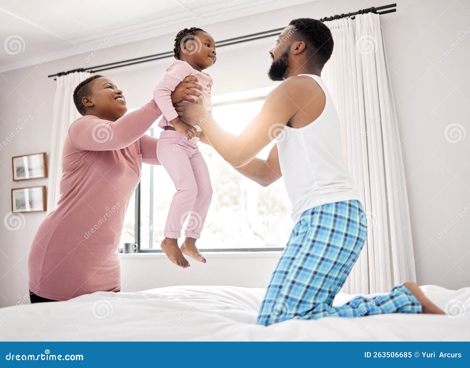 Focused Intent. a Young Family Bonding in Bed Together. Stock Image ...