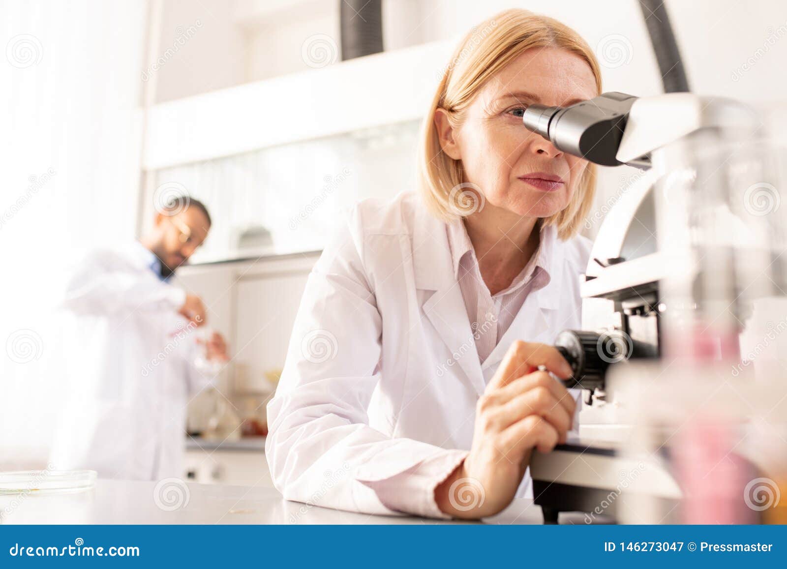 Focused Lady Adjusting Microscope Stock Image - Image of mature ...