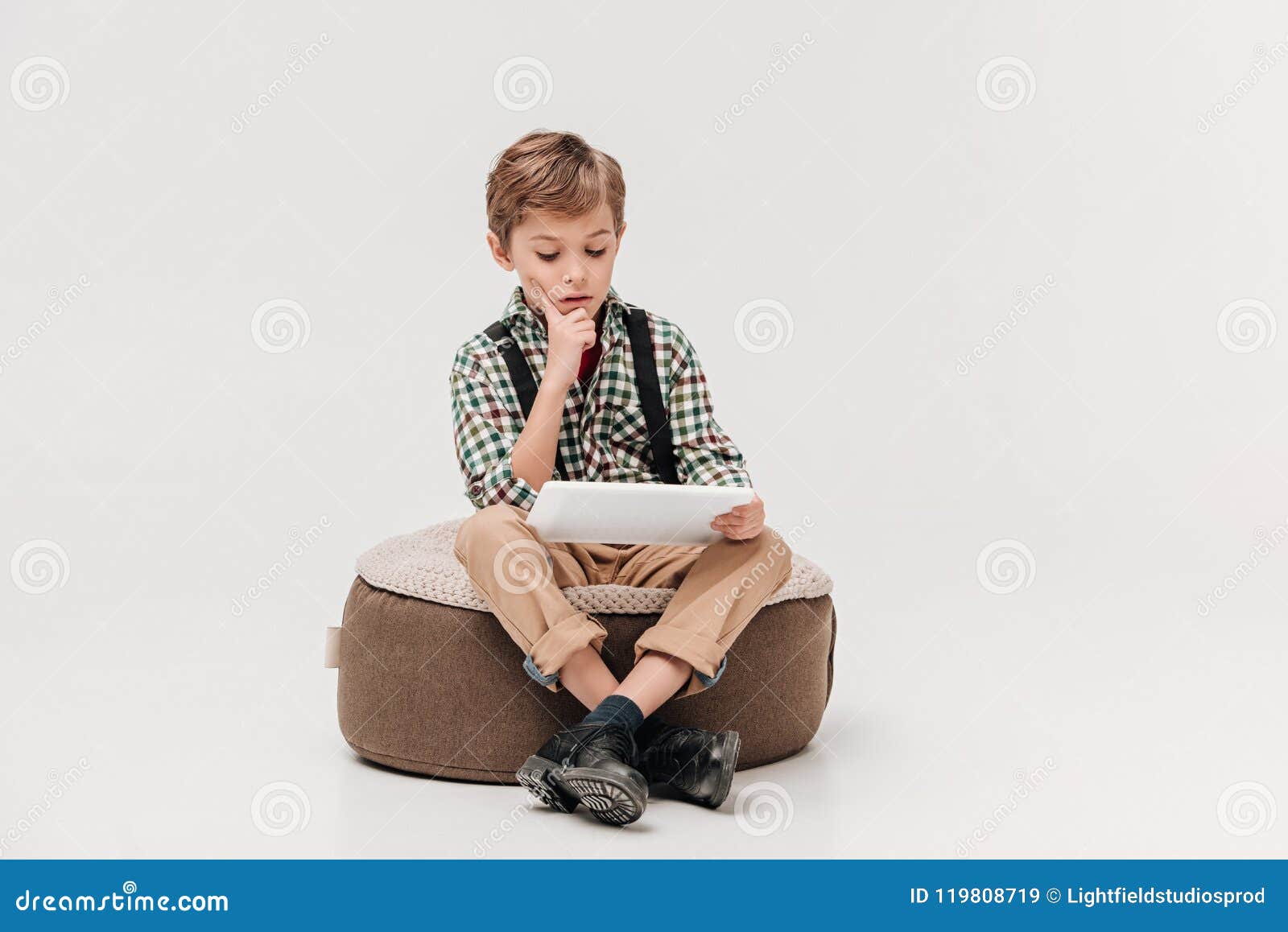Focused Little Boy Sitting and Using Digital Tablet Stock Image - Image ...
