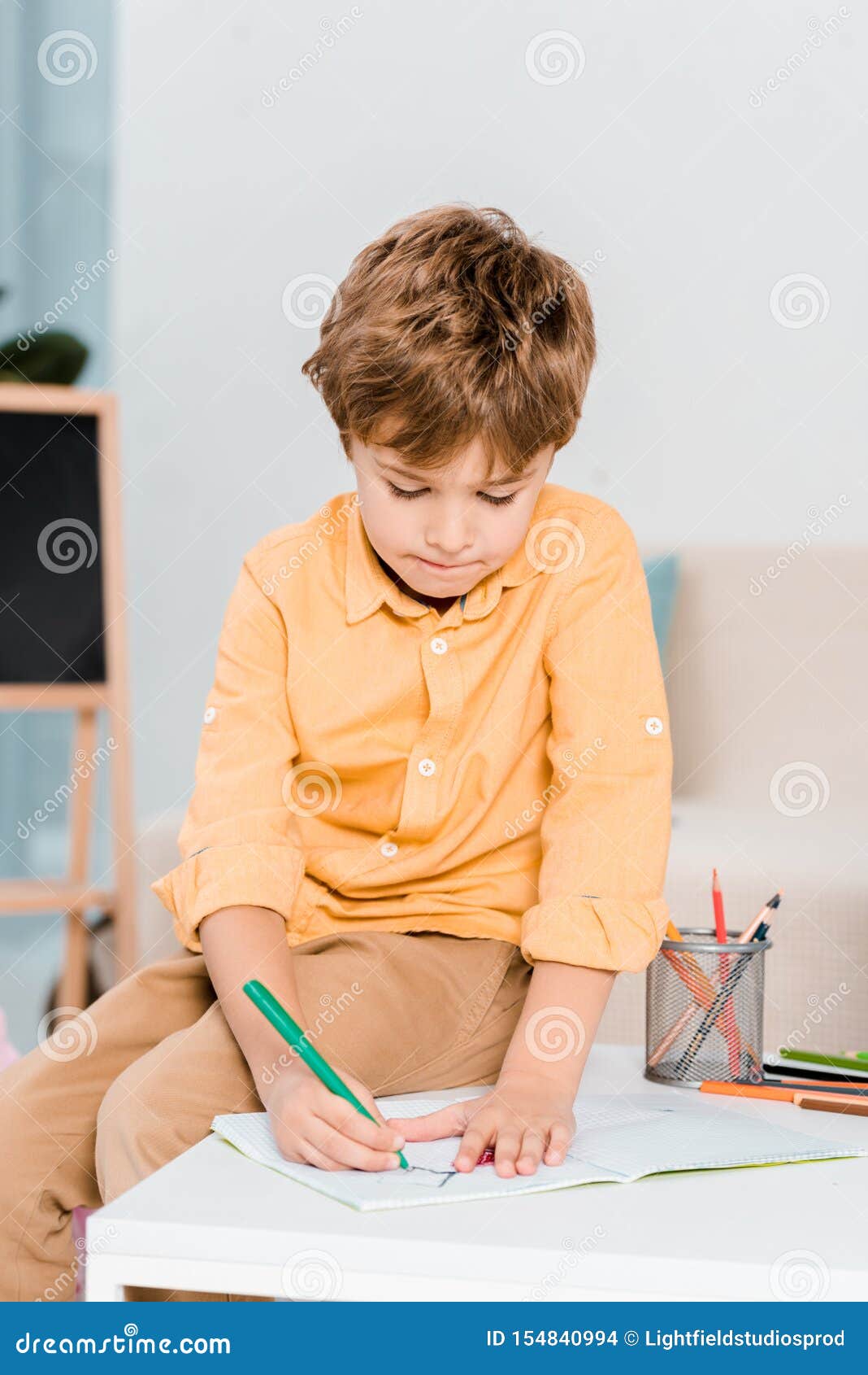 Focused Little Boy Writing and Studying Stock Photo - Image of ...