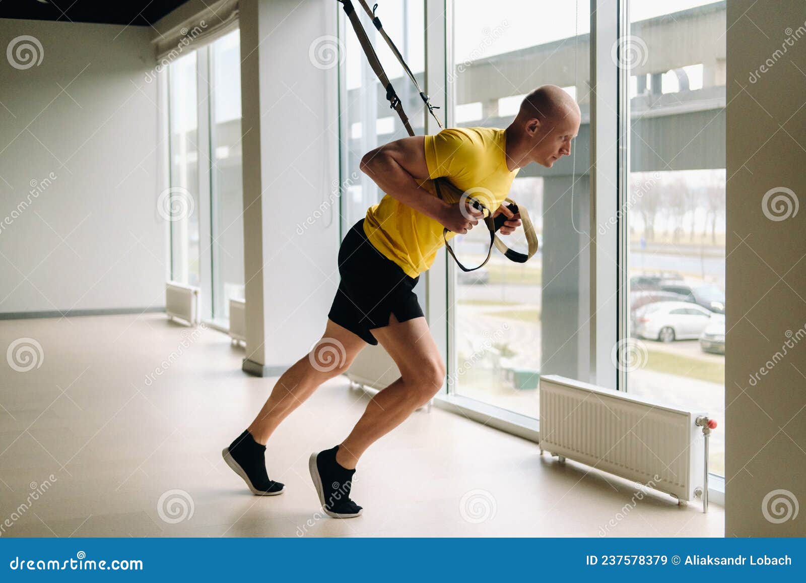 A Focused Male Athlete Performing an Exercise on Functional Loops in ...