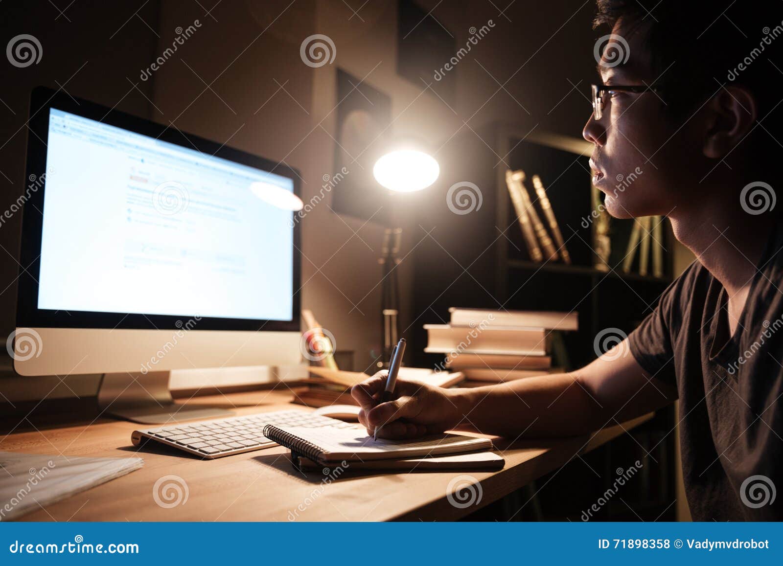 Focused Man Witing and Studying Using Computer in Dark Room Stock Photo ...
