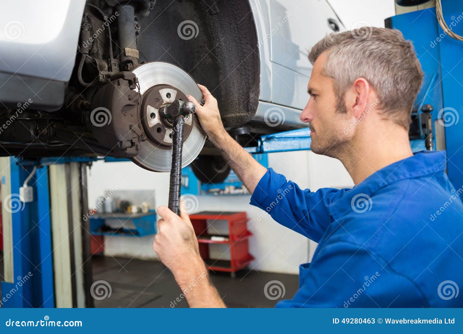 Focused Mechanic Adjusting the Wheel Stock Image - Image of ...