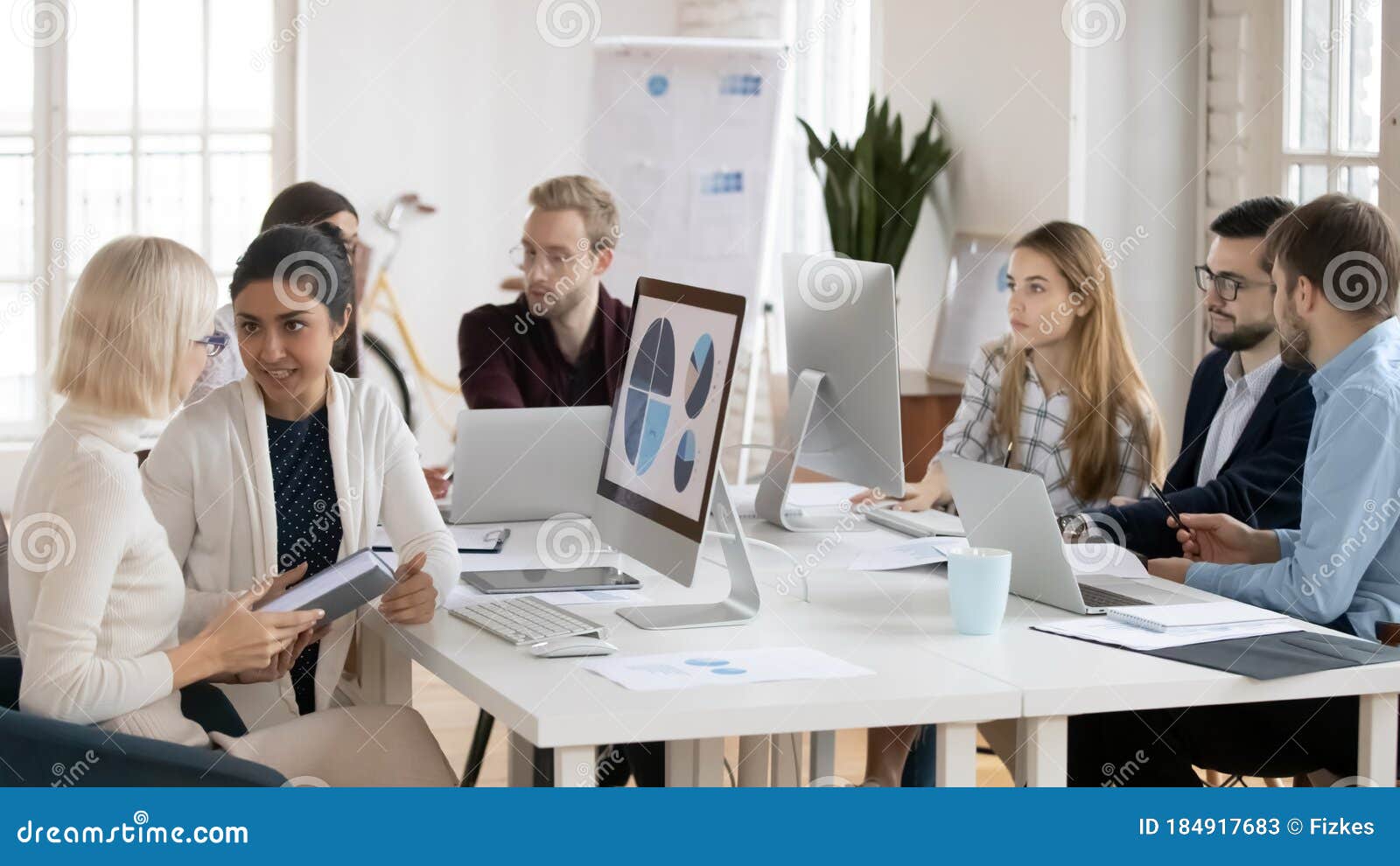 Focused Mixed Race Colleagues Working in Small Groups on Projects ...