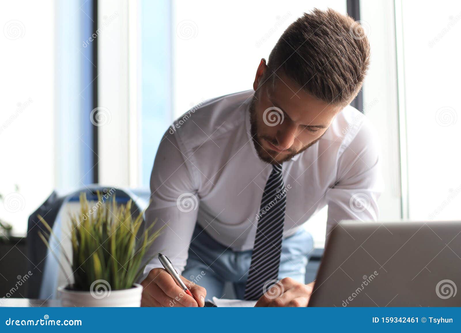 Focused Modern Businessman Working and Taking Notes in His Modern ...