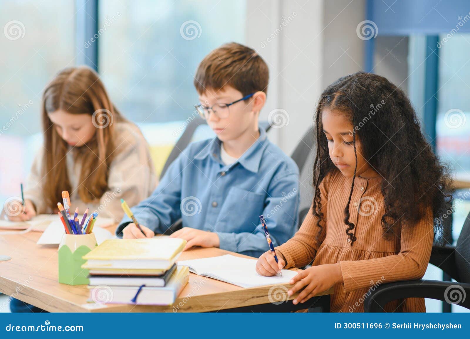 Focused Multiracial Students Kids Writing Down Data into Notebook while ...